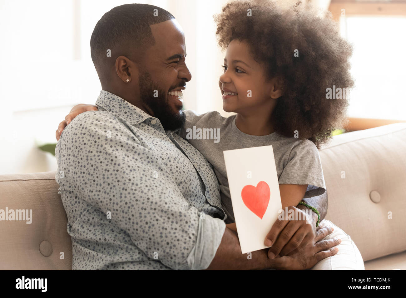 Happy african dad and kid daughter embracing celebrate fathers day ...