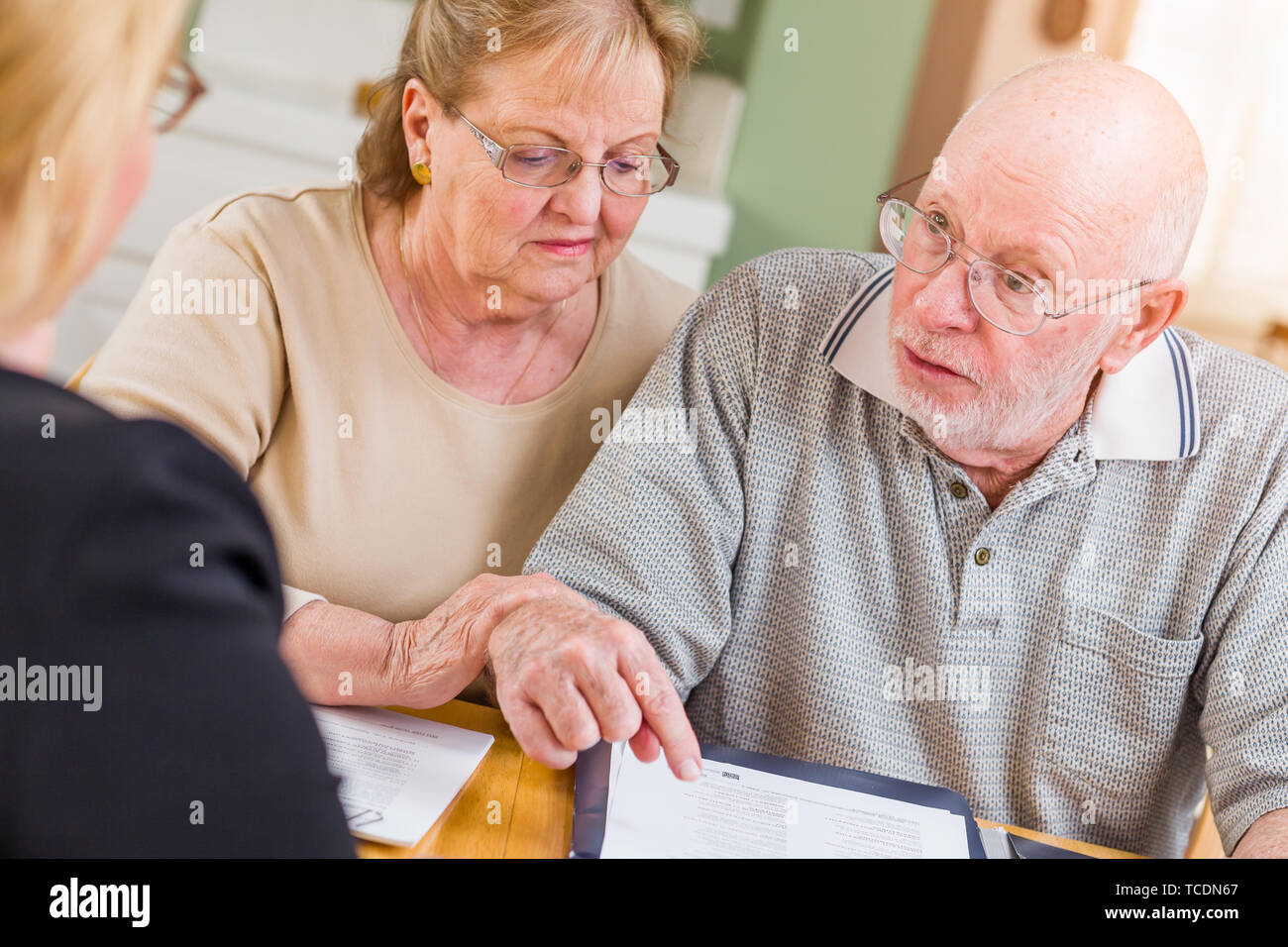 Senior couple signing documents hi-res stock photography and images - Alamy