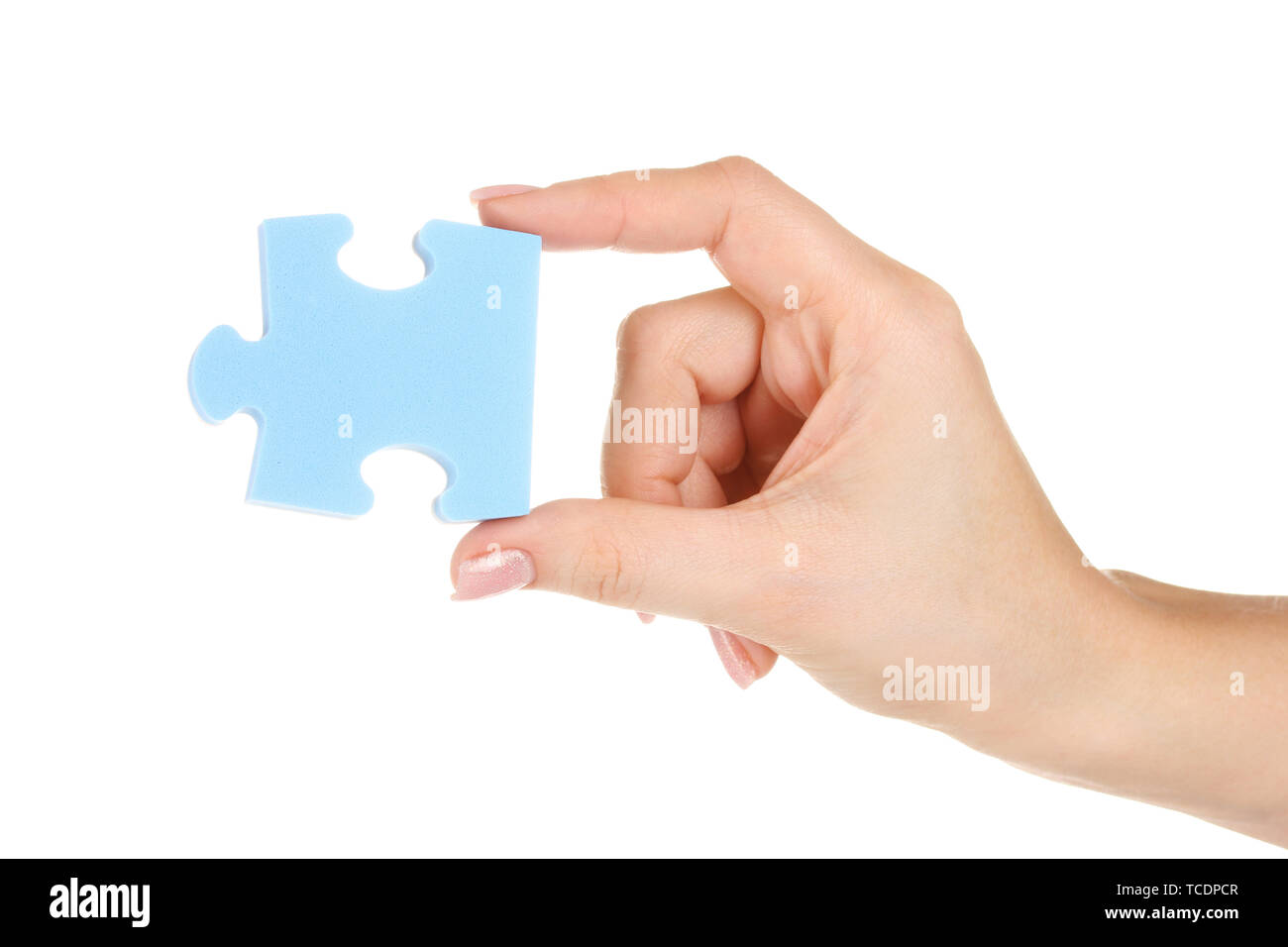 Blue puzzle with a hand isolated on white Stock Photo - Alamy