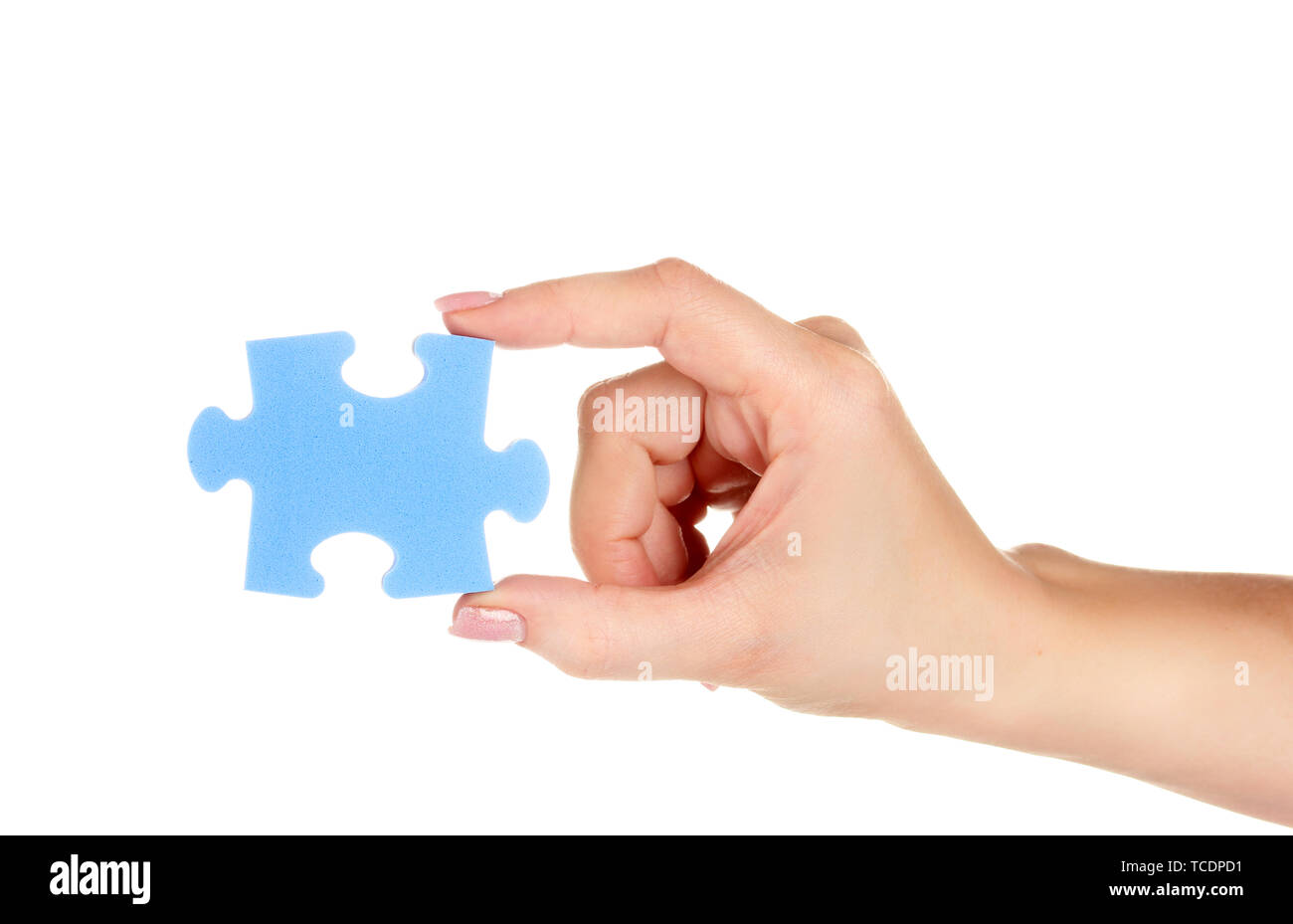 Blue puzzle with a hand isolated on white Stock Photo - Alamy