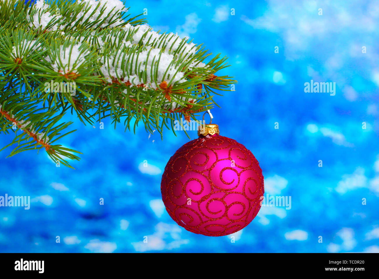 Christmas ball on the tree on blue Stock Photo - Alamy