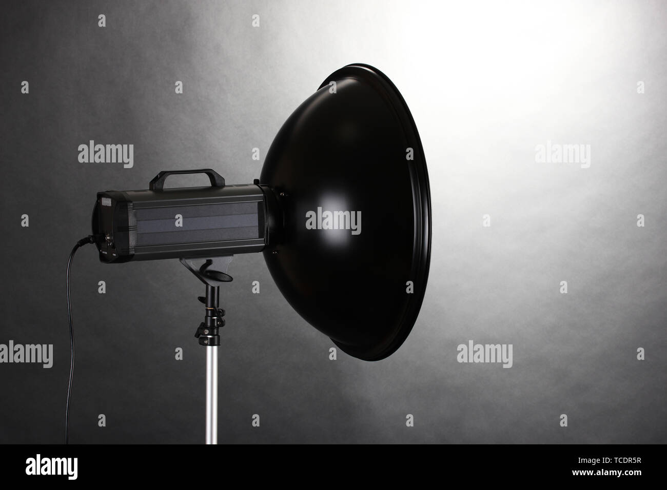 Studio flash on grey background Stock Photo - Alamy