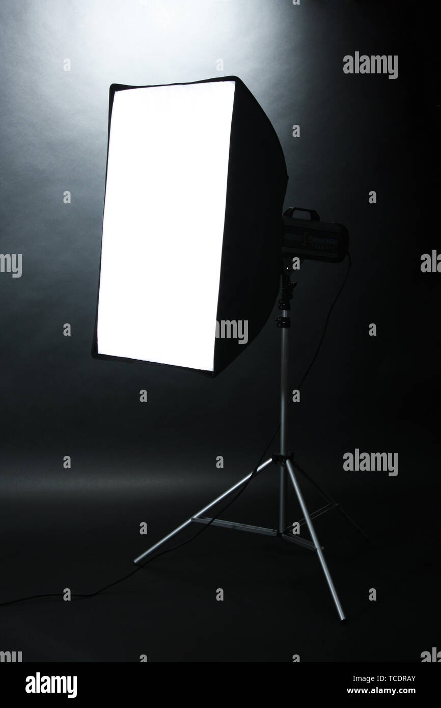 Studio flash with soft-box on black studio background Stock Photo - Alamy