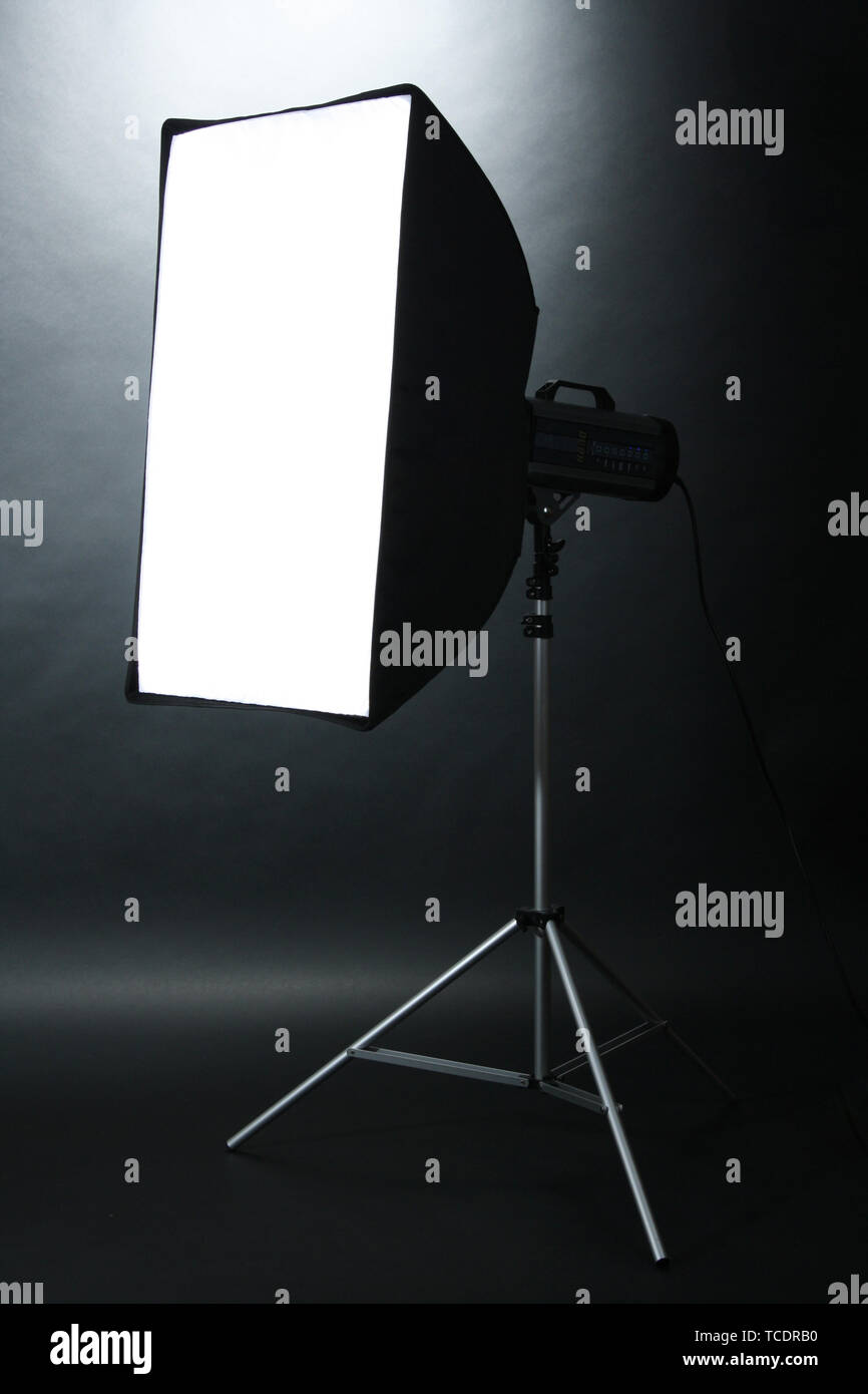 Studio flash with soft-box on black studio background Stock Photo - Alamy