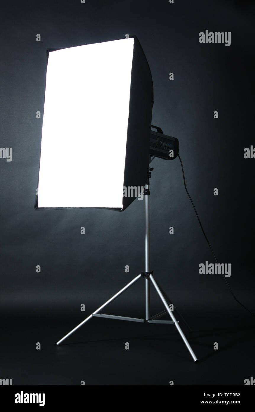 Studio flash with soft-box on black studio background Stock Photo - Alamy