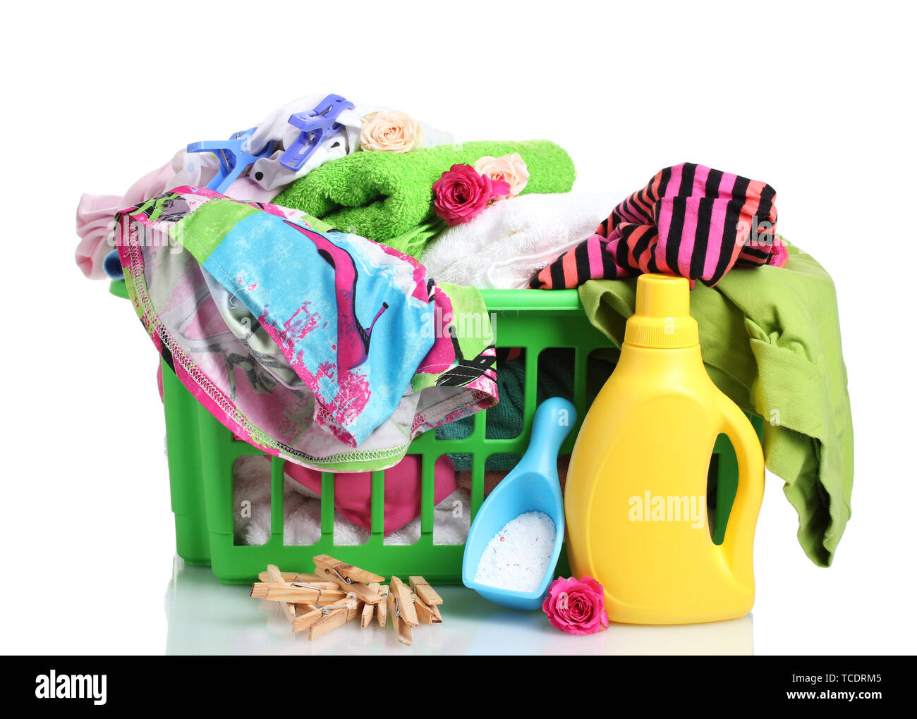 Clothes with detergent and washing powder in green plastic basket ...