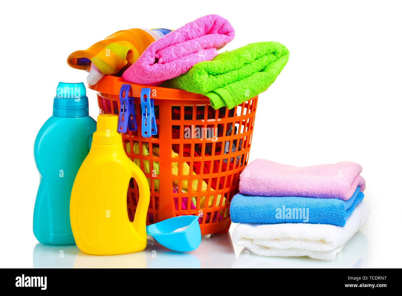 Clothes with detergent and washing powder in orange plastic basket ...