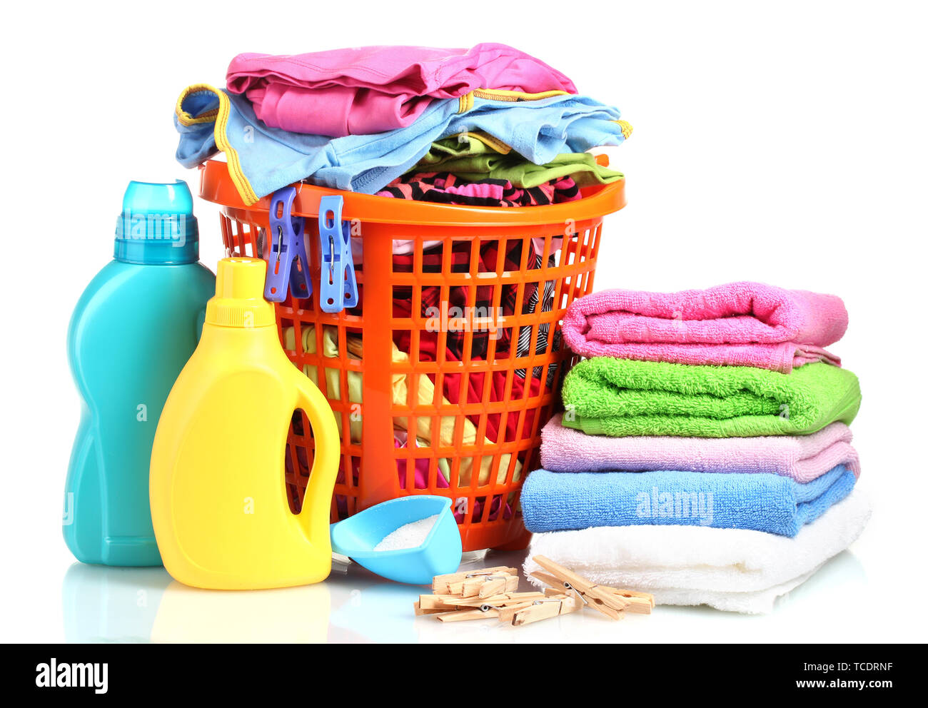 Clothes with detergent and washing powder in orange plastic basket ...