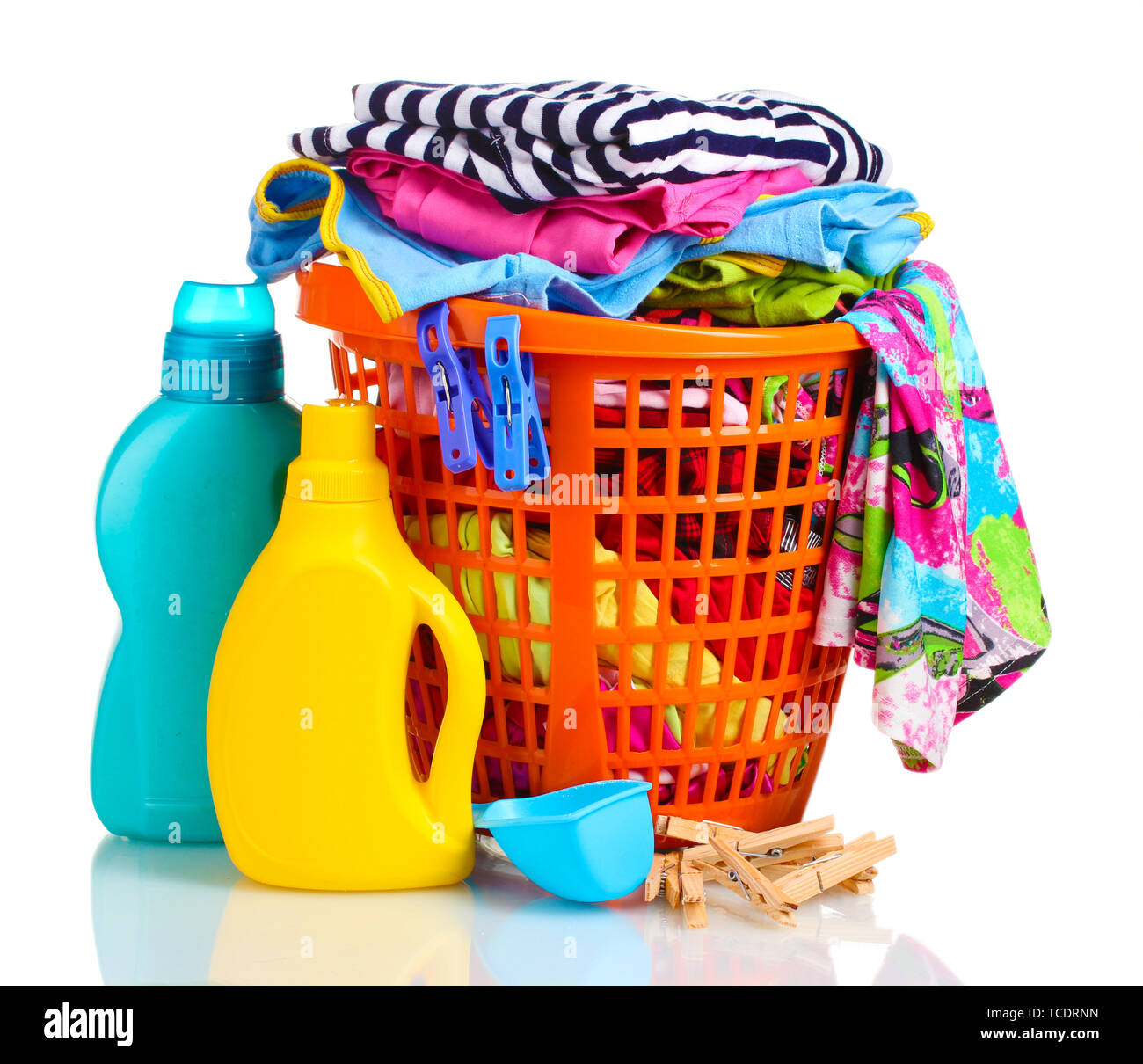 Clothes with detergent and washing powder in orange plastic basket ...