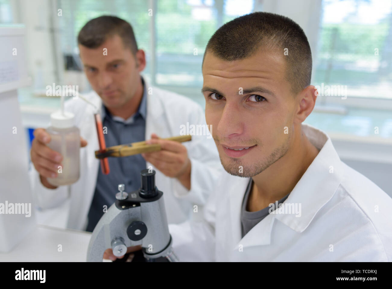 Serious chemist examining beaker hi-res stock photography and images ...