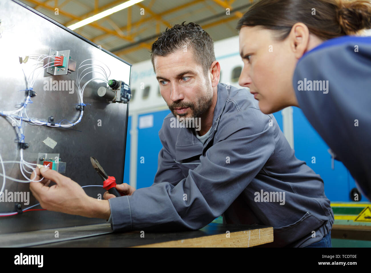 worker cutting cables Stock Photo - Alamy