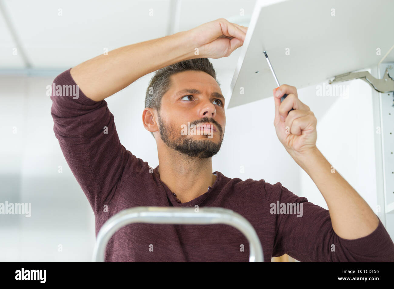 technician man installing kitchen cabinets Stock Photo - Alamy