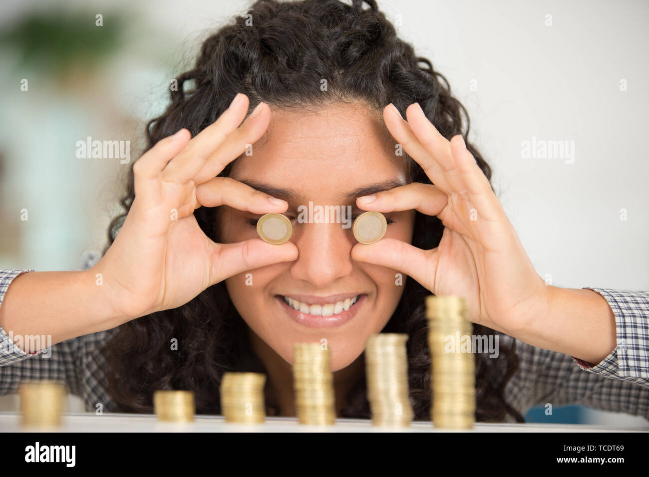 coins on the eyes as symbol of love money Stock Photo - Alamy