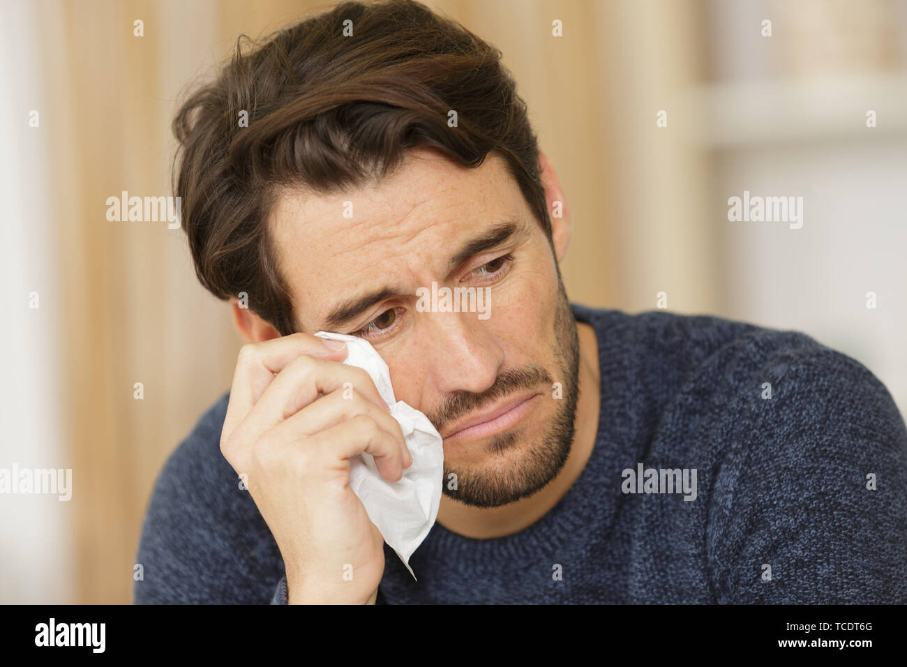 man crying at home Stock Photo - Alamy