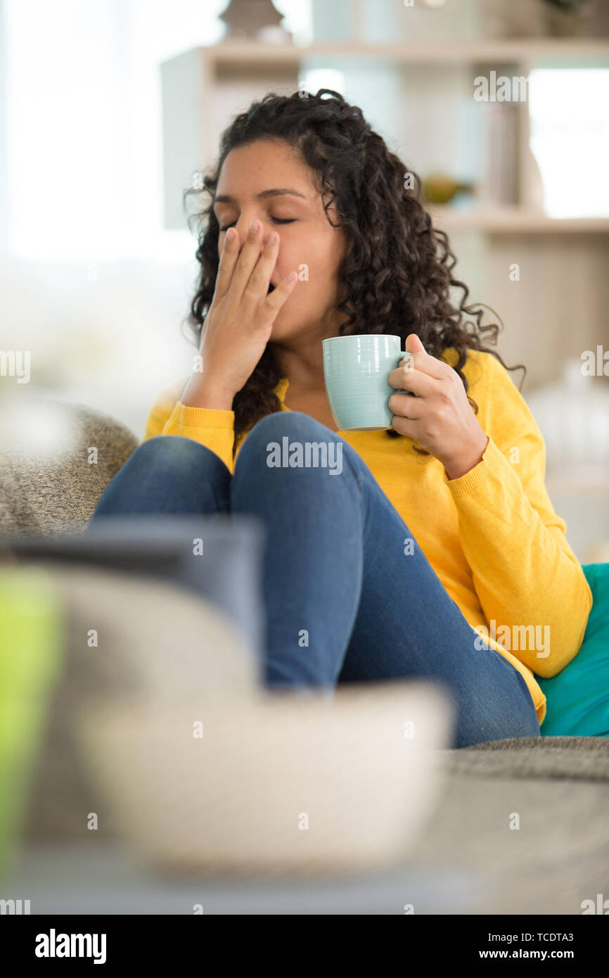 Woman yawing sofa hi-res stock photography and images - Alamy
