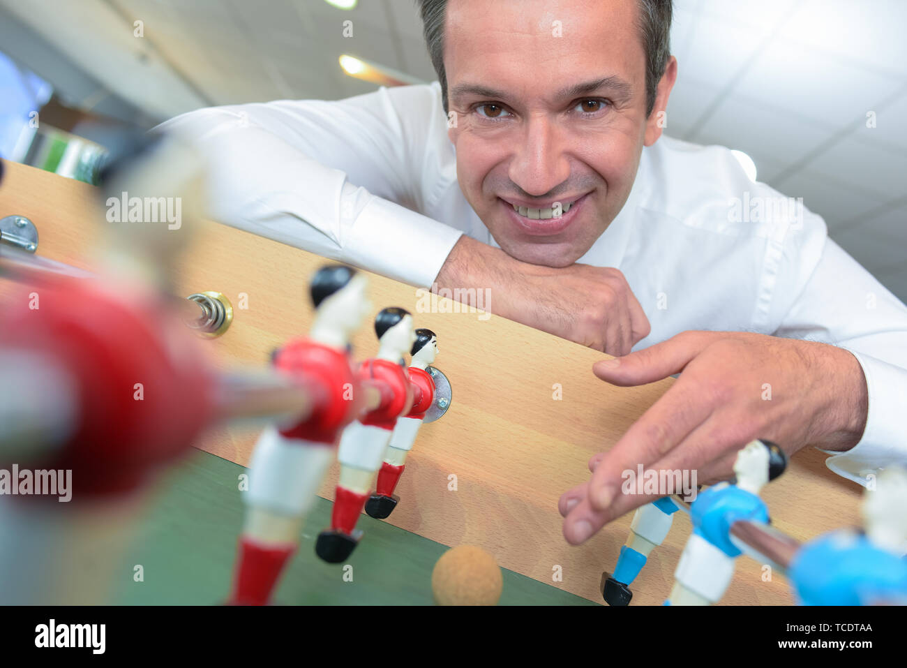 man presenting table football game Stock Photo - Alamy