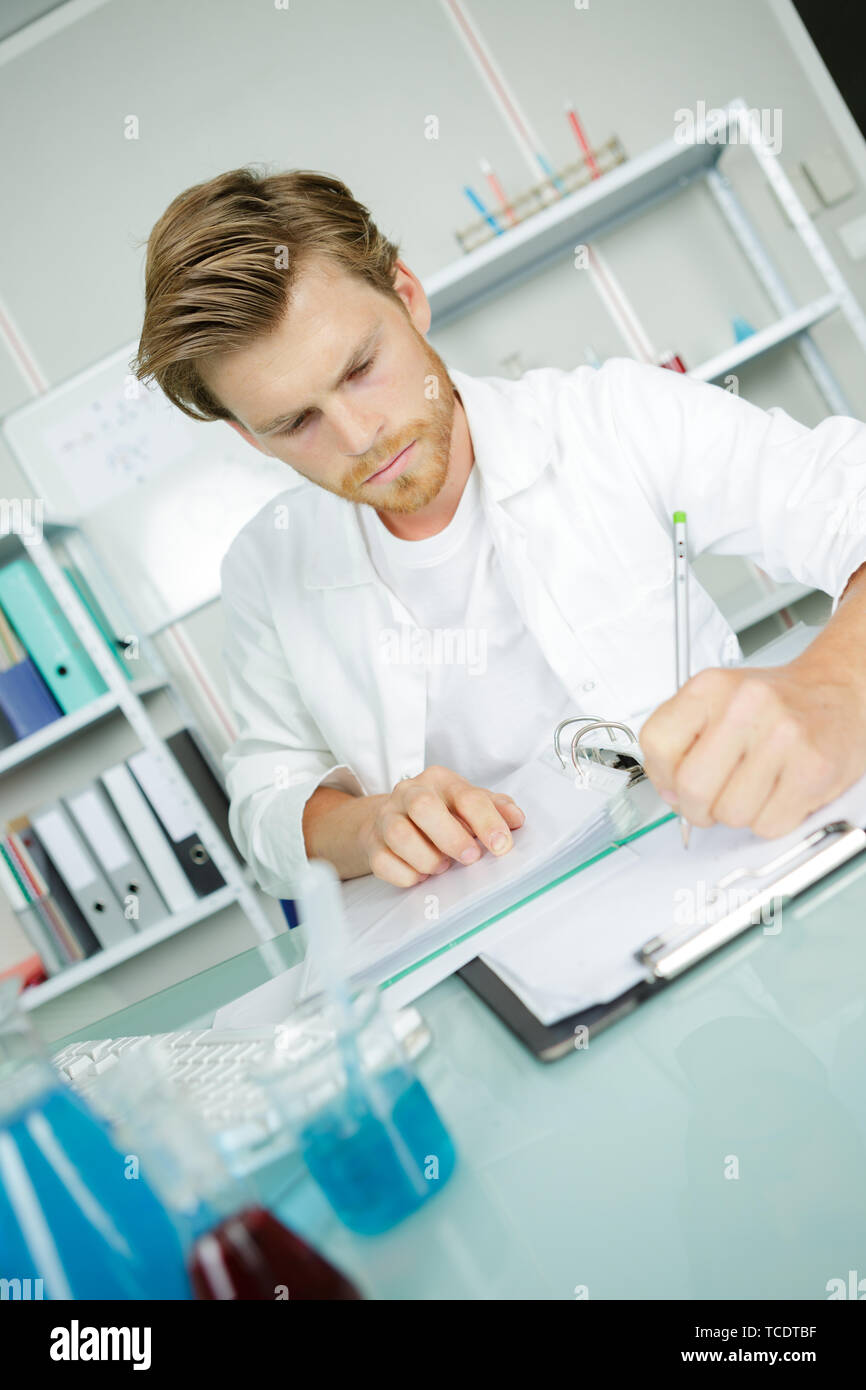 scientist makes a note of experiment in the laboratory Stock Photo - Alamy