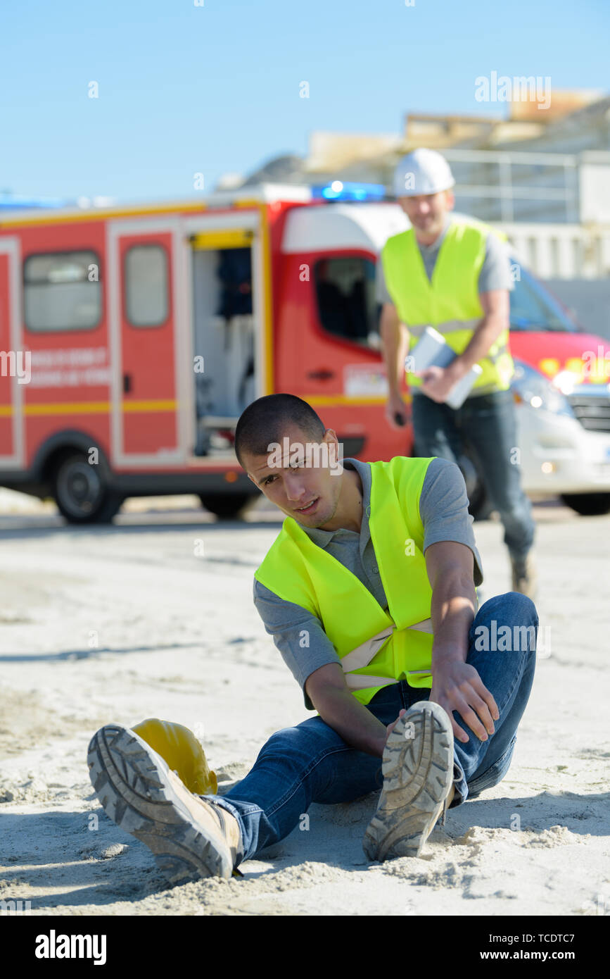 young construction worker suffering leg injury on site Stock Photo - Alamy