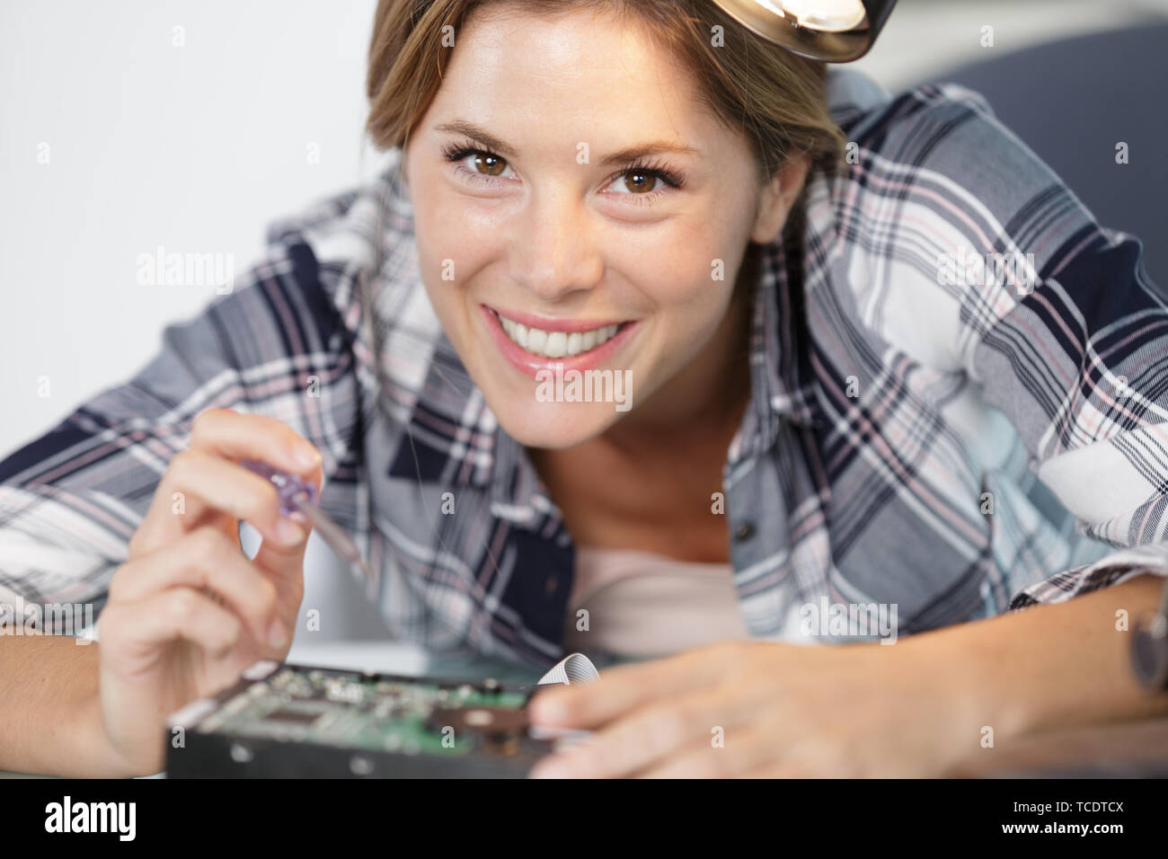 happy young female pc technician looking at camera Stock Photo - Alamy