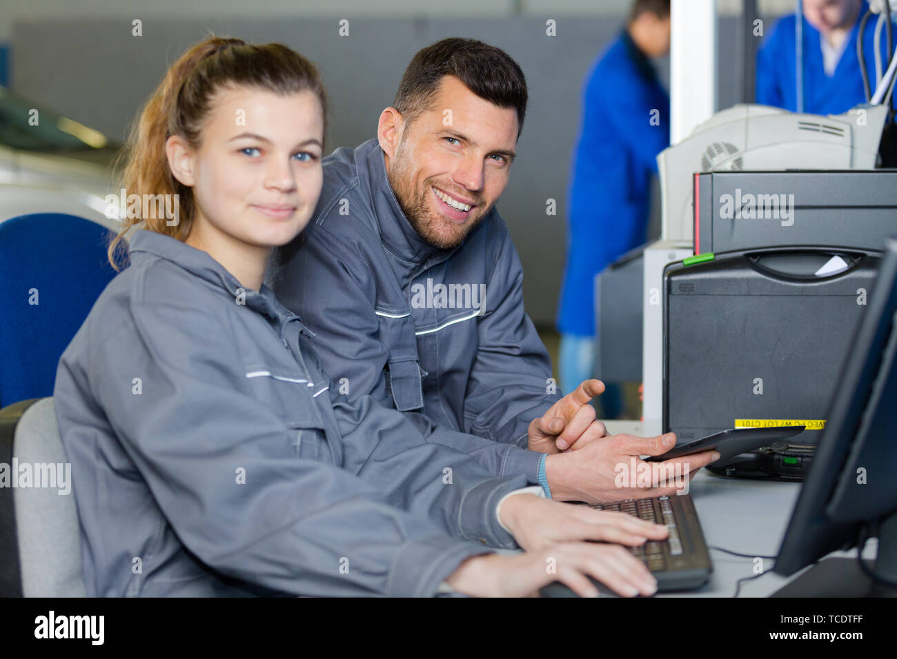 trainee engineer using computer with tutor Stock Photo - Alamy