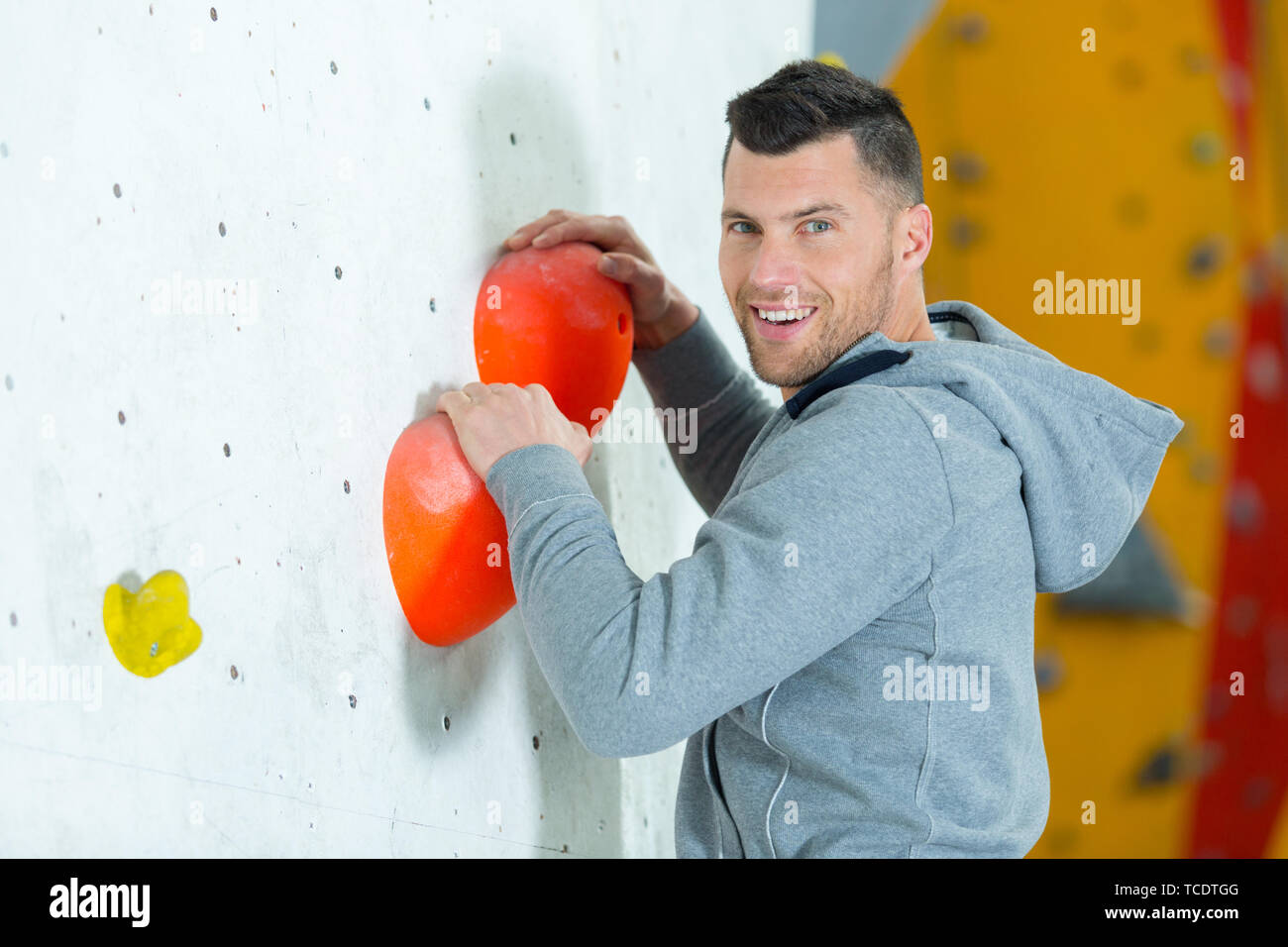 strong man climbing up the wall Stock Photo - Alamy