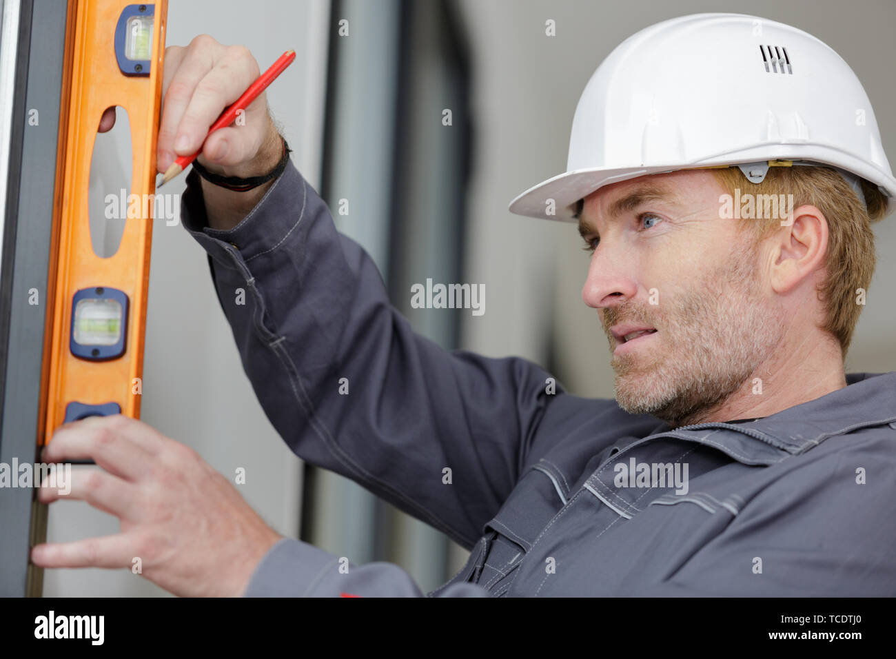 Skilled construction worker using spirit hi-res stock photography and ...