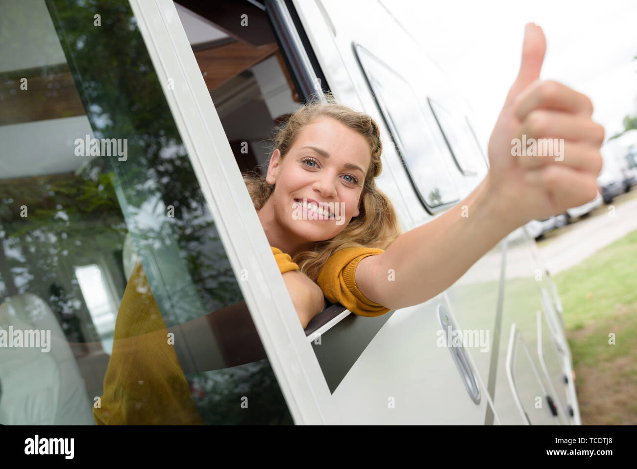 beautiful girl with thumbs up in a van Stock Photo - Alamy
