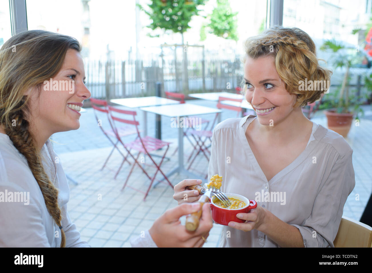 pretty young women having lunch in the restaurant Stock Photo - Alamy