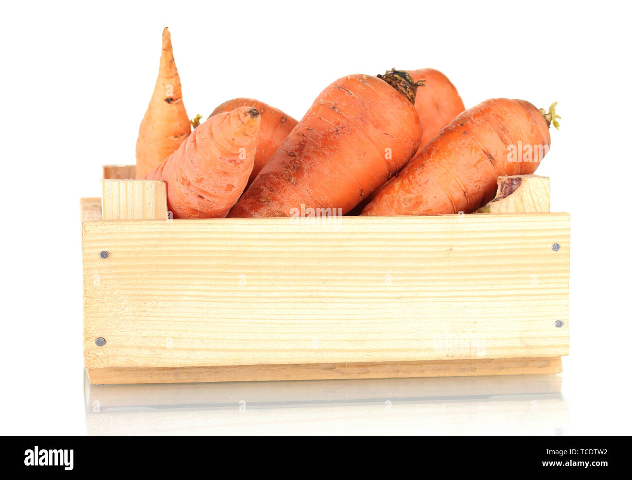 raw carrots in wooden box isolated on white Stock Photo - Alamy