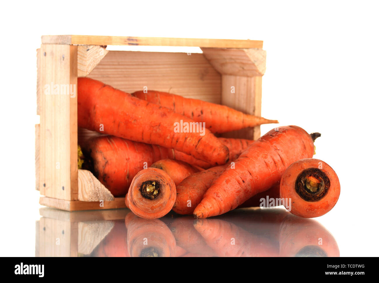 raw carrots in wooden box isolated on white Stock Photo - Alamy