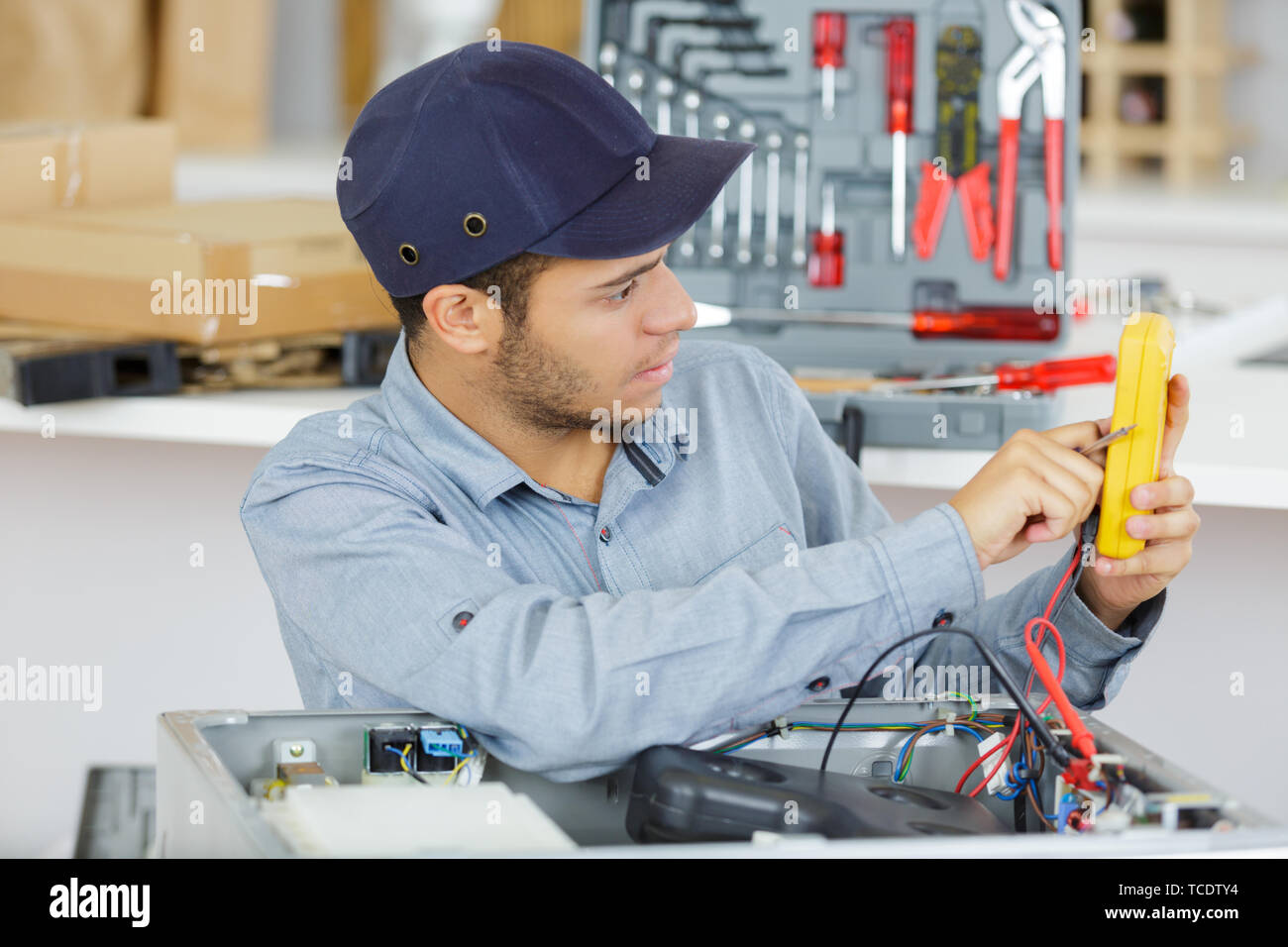 technician adjust the overload relay in electrical terminal box Stock ...