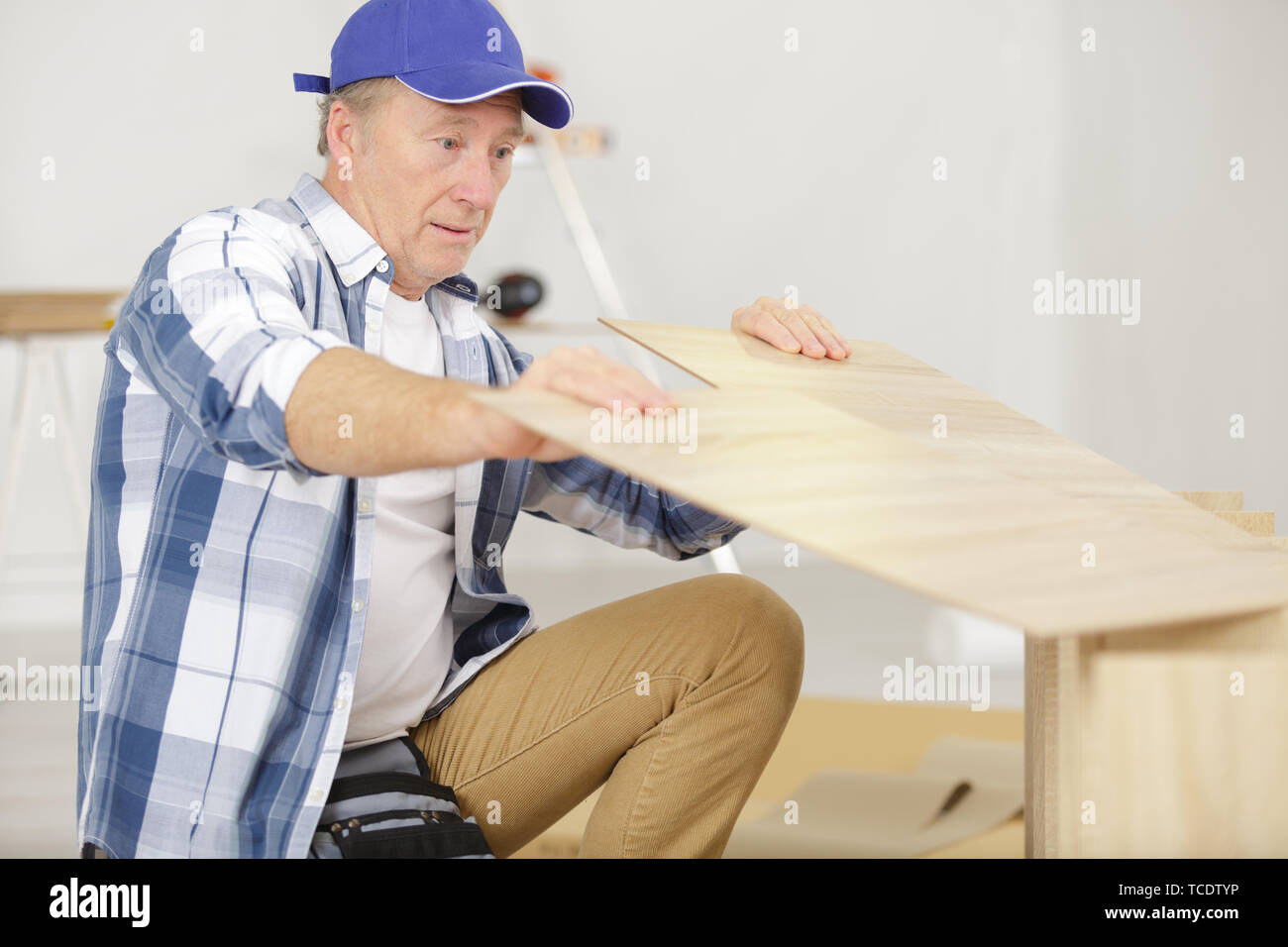 man checking wood planks Stock Photo - Alamy