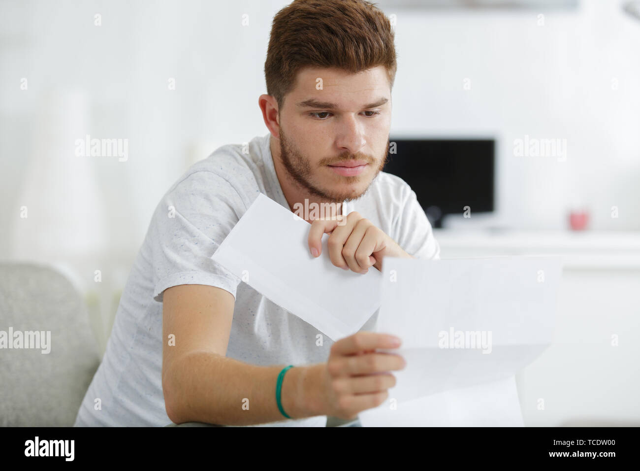 man reading letter and upset bad news mail Stock Photo - Alamy