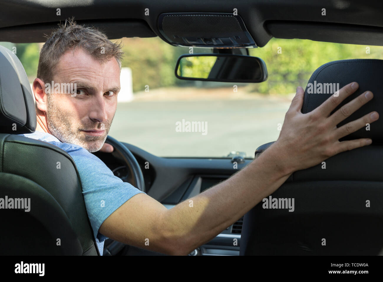 handsome man is driving in reverse Stock Photo - Alamy