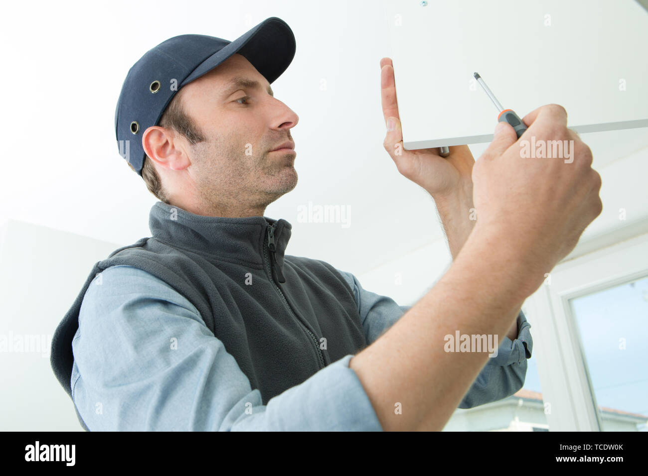 worker assembling a furniture Stock Photo - Alamy