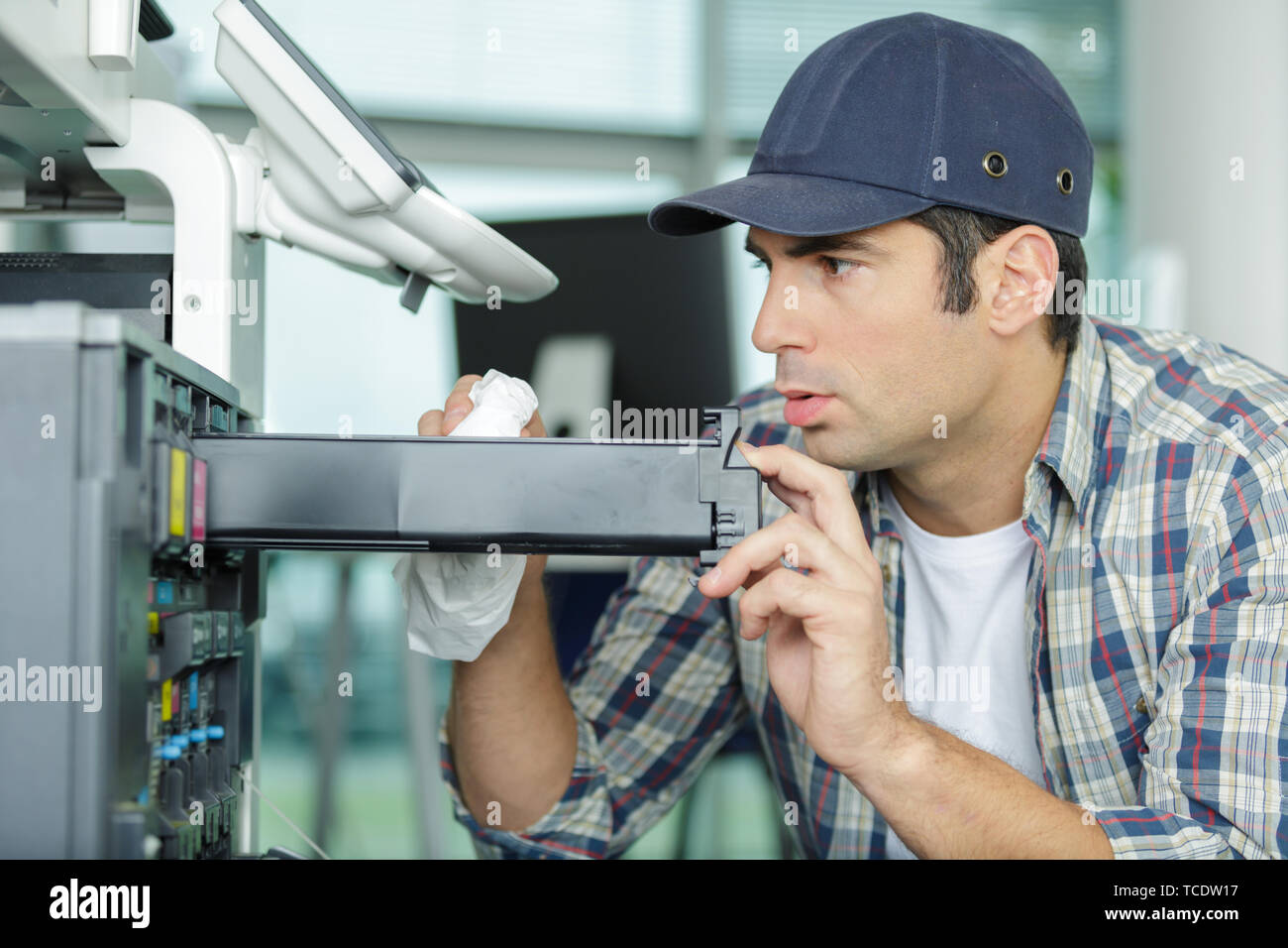 middle age man fixing a printer Stock Photo - Alamy