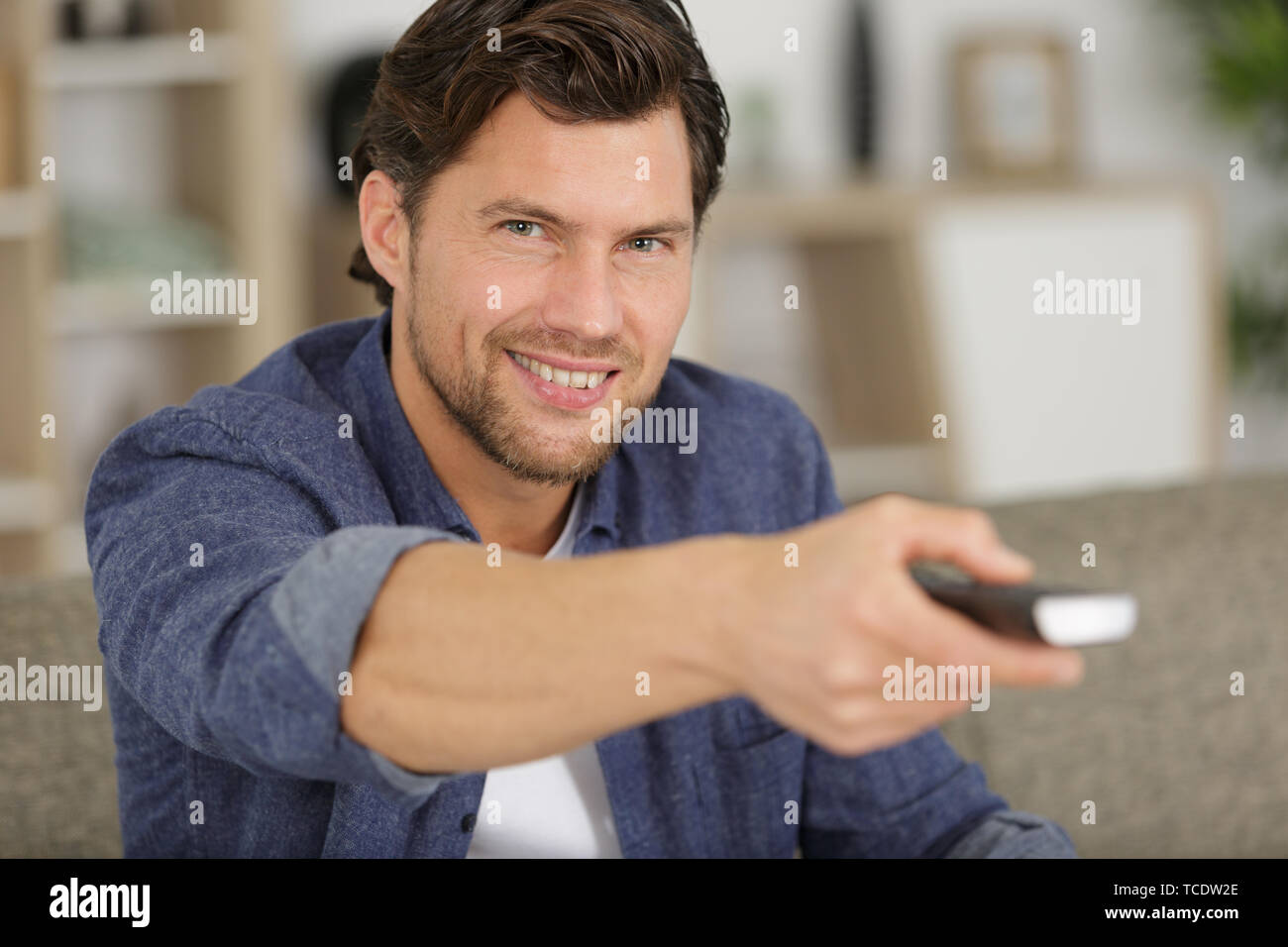 Hand tv remote turning off hi-res stock photography and images - Alamy