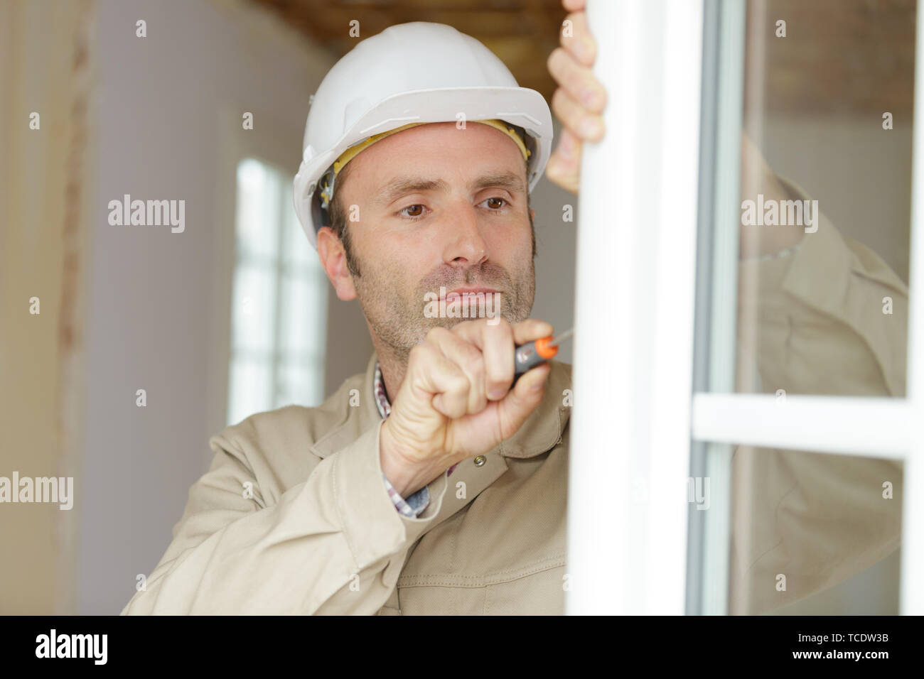 construction worker installing window in house Stock Photo - Alamy
