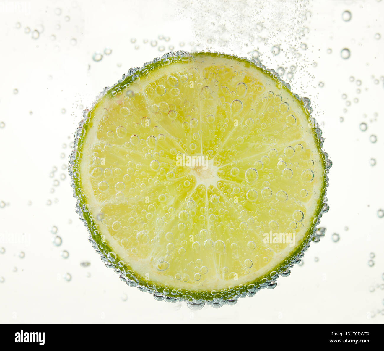 slice of lime in the water with bubbles Stock Photo - Alamy