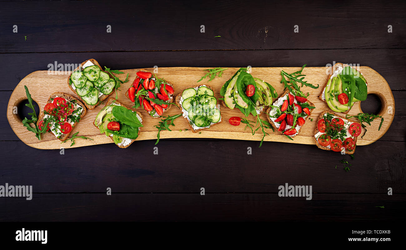 Flat lay of healthy vegetarian dinner table setting. Sandwiches with ...