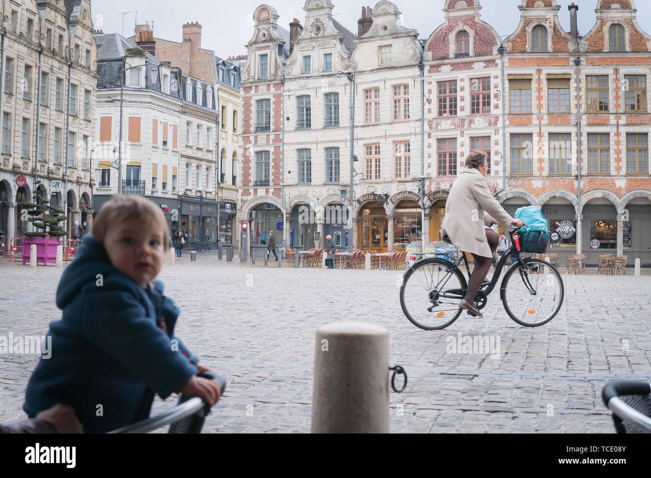 Arras, France - may 2, 2019 - a woman on the cyle on the main city ...