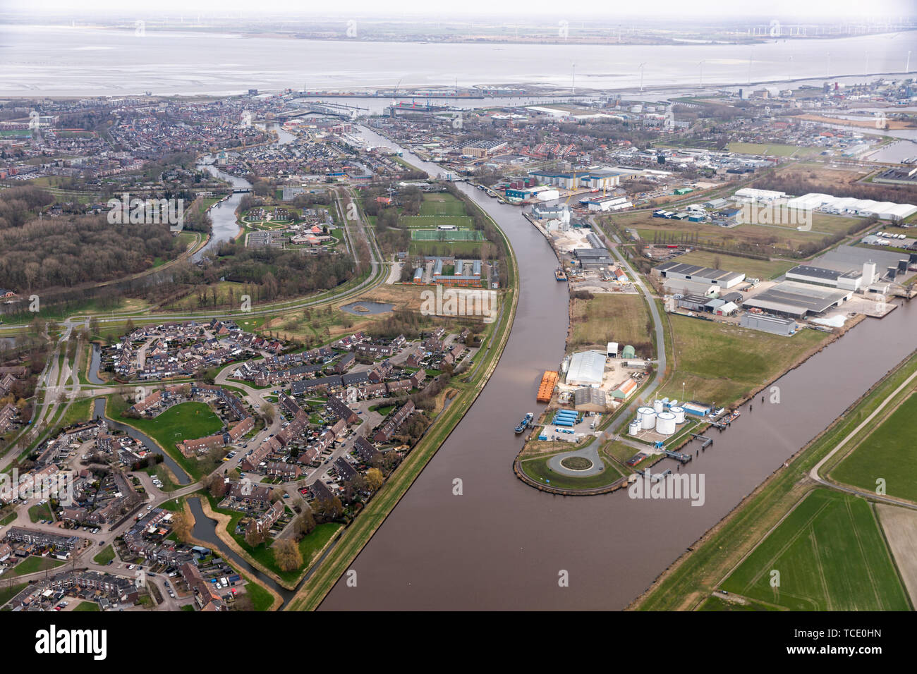 Aerial view Dutch residential area Delfzijl with channel and harbor ...