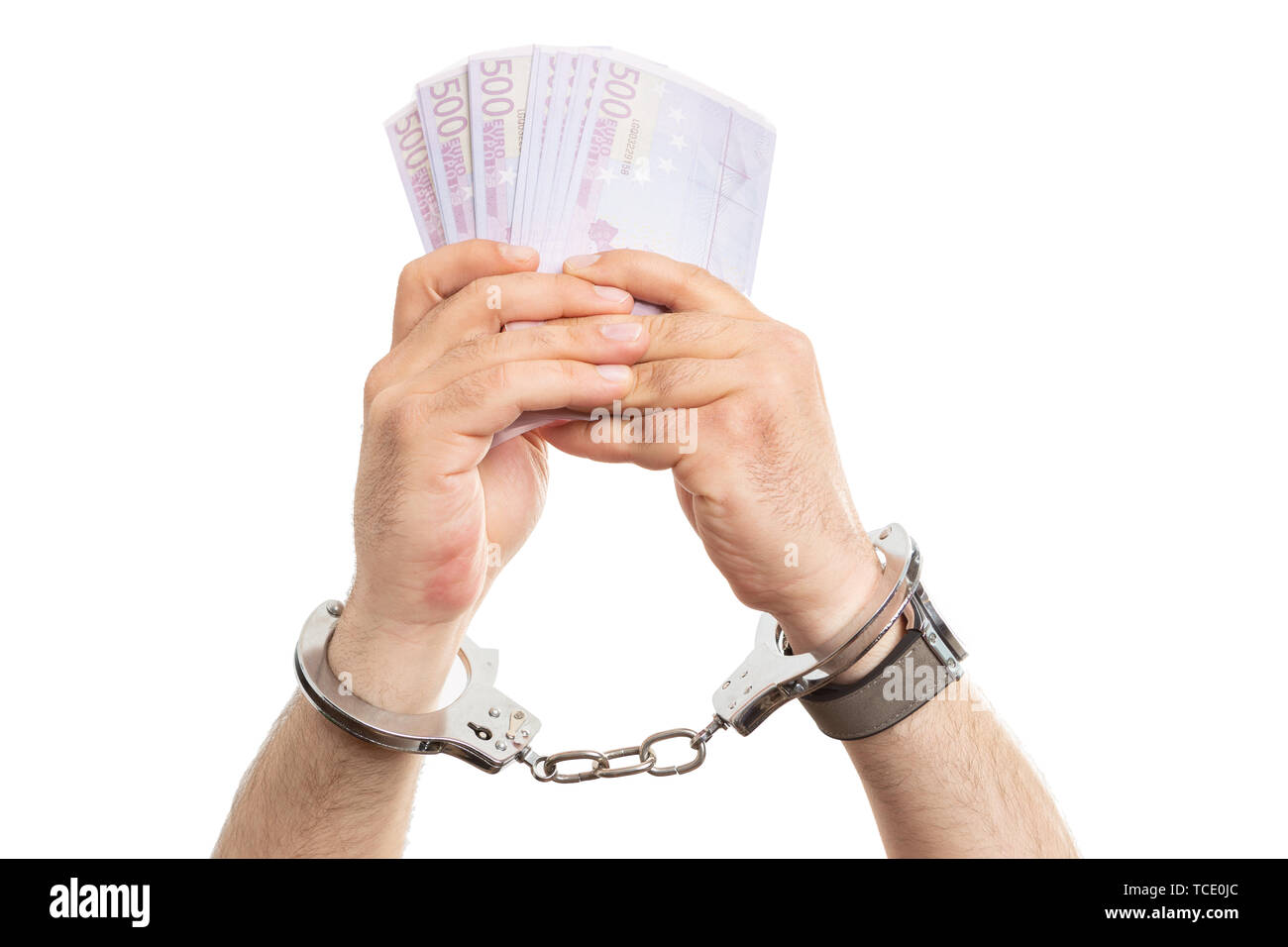 Closeup of handcuffed man presenting cash money as corruption concept ...