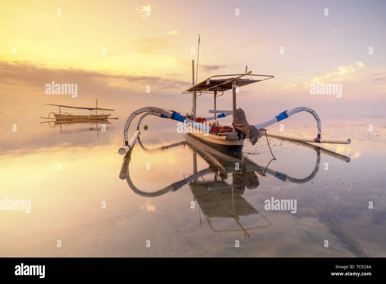 Two traditional jukung boat anchored on beach, Sanur, Bali, Indonesia ...