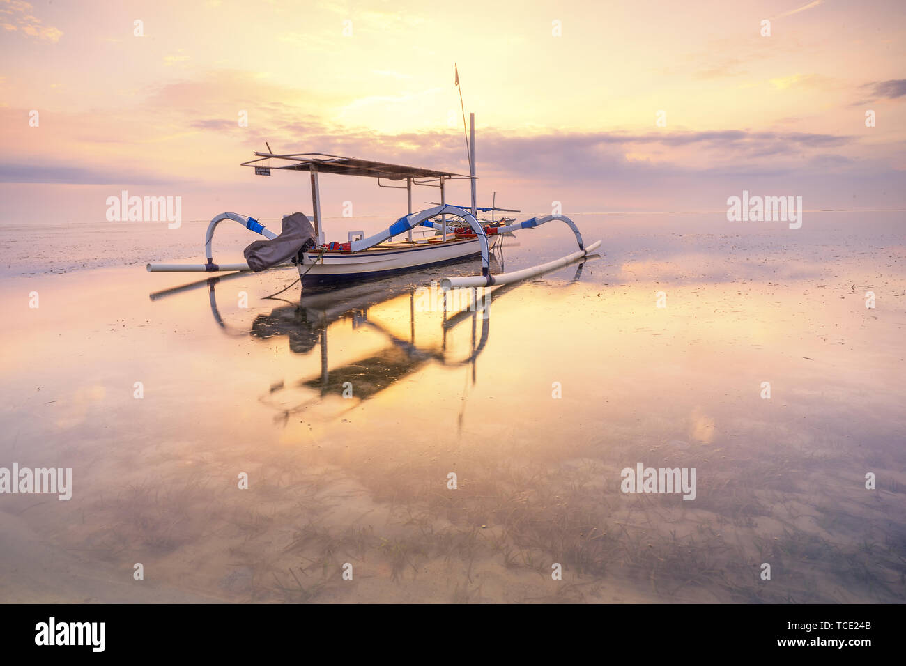 Traditional jukung boat anchored on beach, Sanur, Bali, Indonesia Stock ...