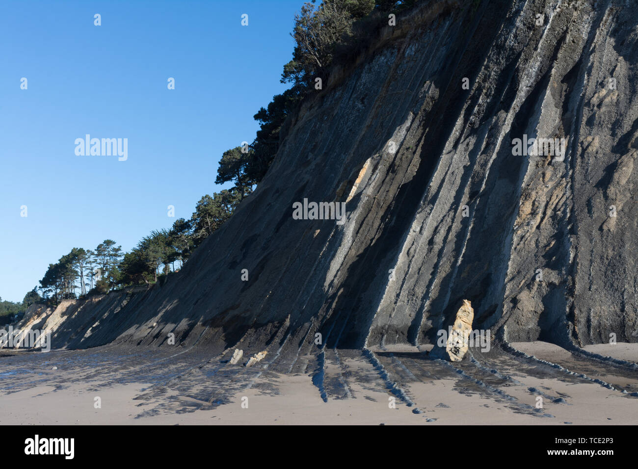 A huge cliff face with sun light grazing the side Stock Photo - Alamy