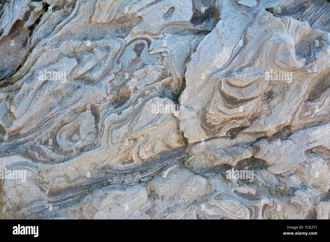 Natural occurring swirls and circles in a layerd rock face Stock Photo ...