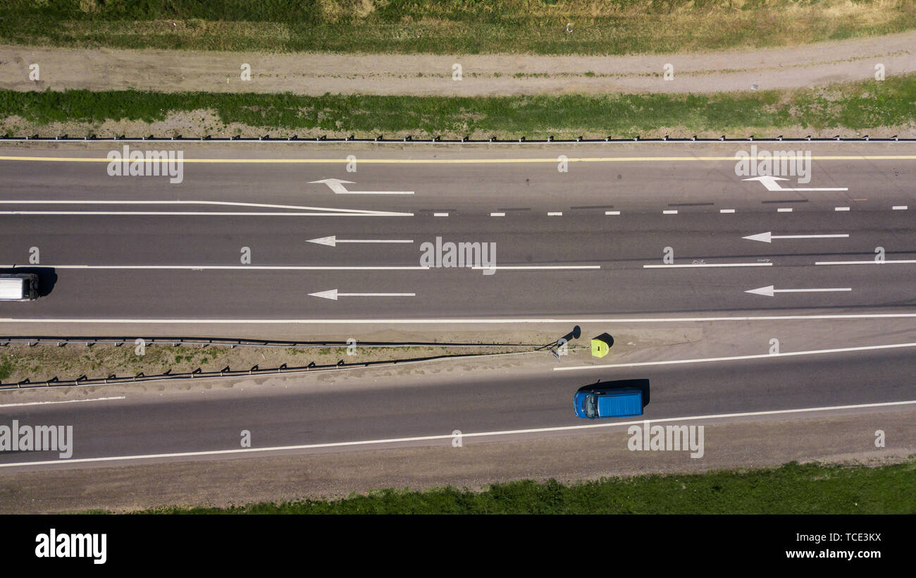 Top down close up of road, asphalt, white arrow signs indicating ...