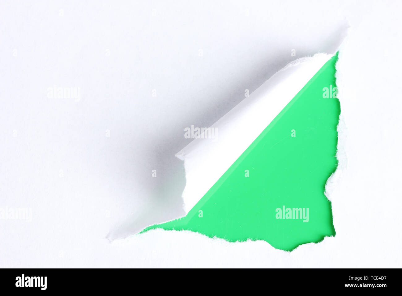 Torn paper with green background Stock Photo - Alamy