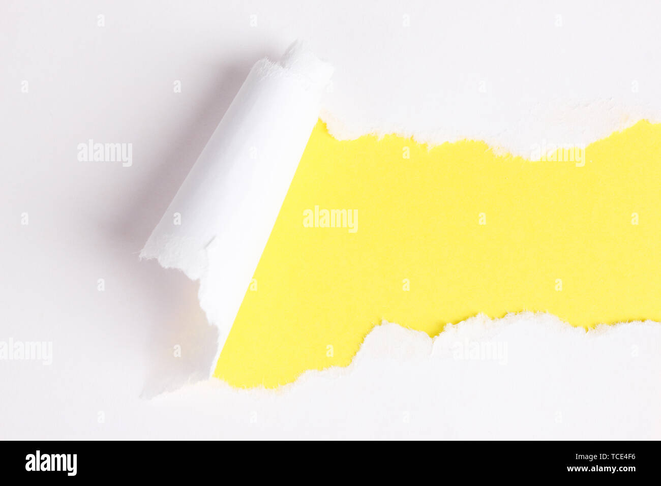 Torn paper with yellow background Stock Photo - Alamy